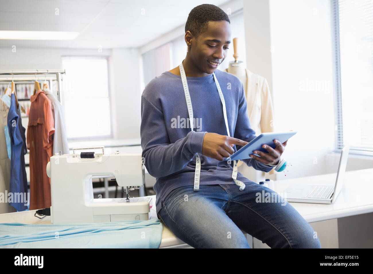 Smiling university student using tablet pc Stock Photo - Alamy