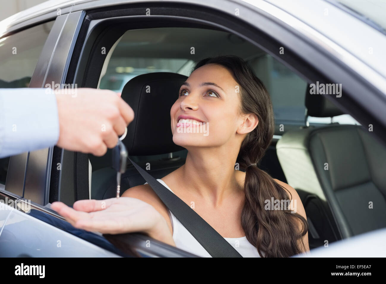 Young woman getting her key Stock Photo - Alamy