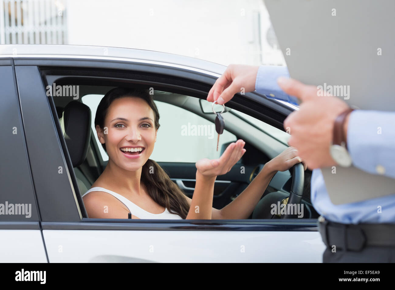 Young woman getting her key Stock Photo - Alamy