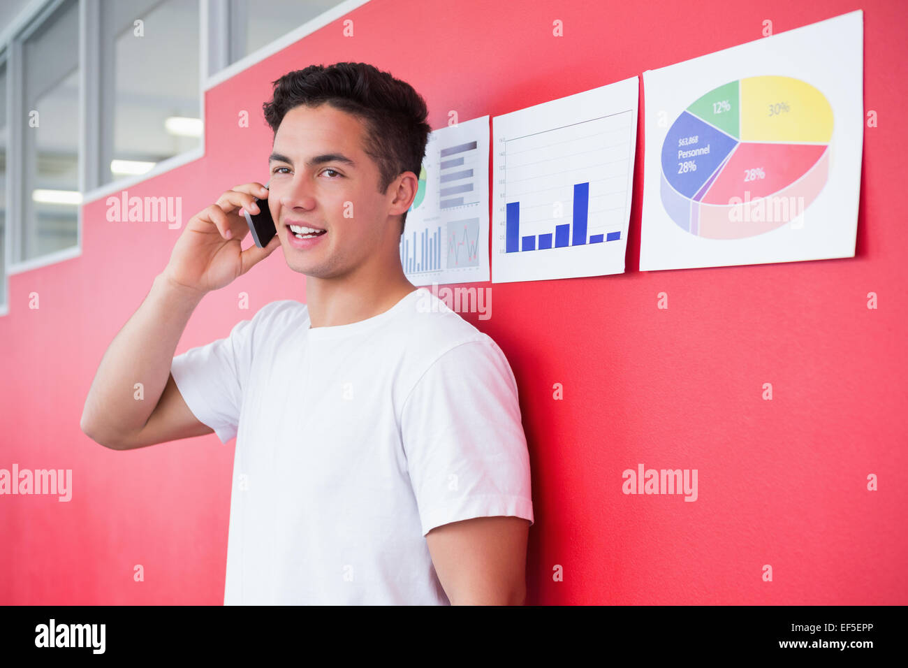 Smiling student on the phone standing Stock Photo - Alamy