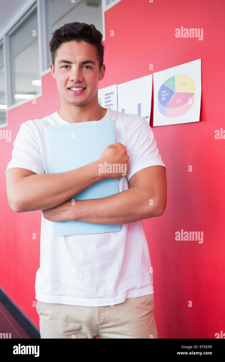 Smiling student holding notebook Stock Photo - Alamy