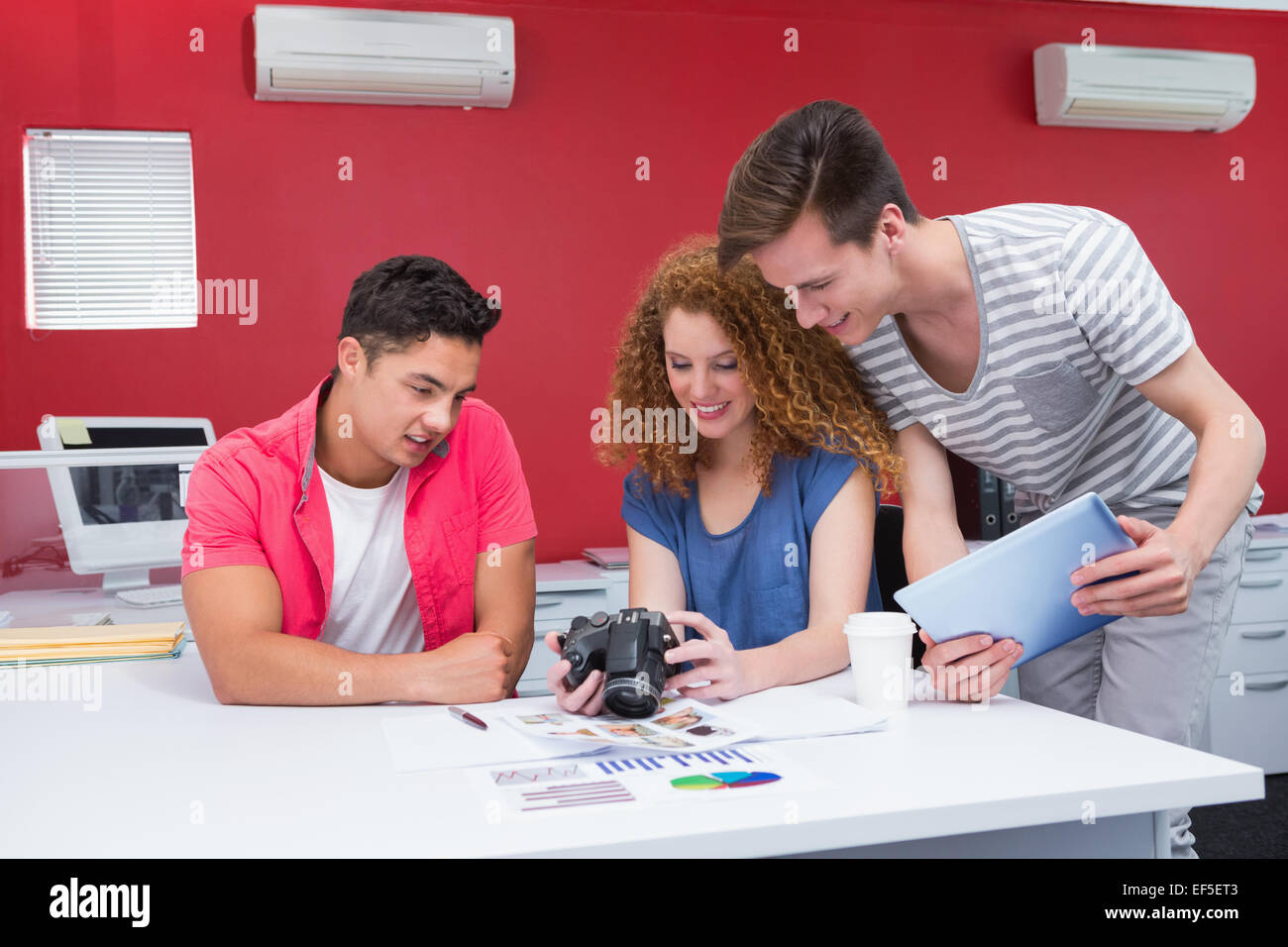 Smiling students working with camera and tablet Stock Photo - Alamy