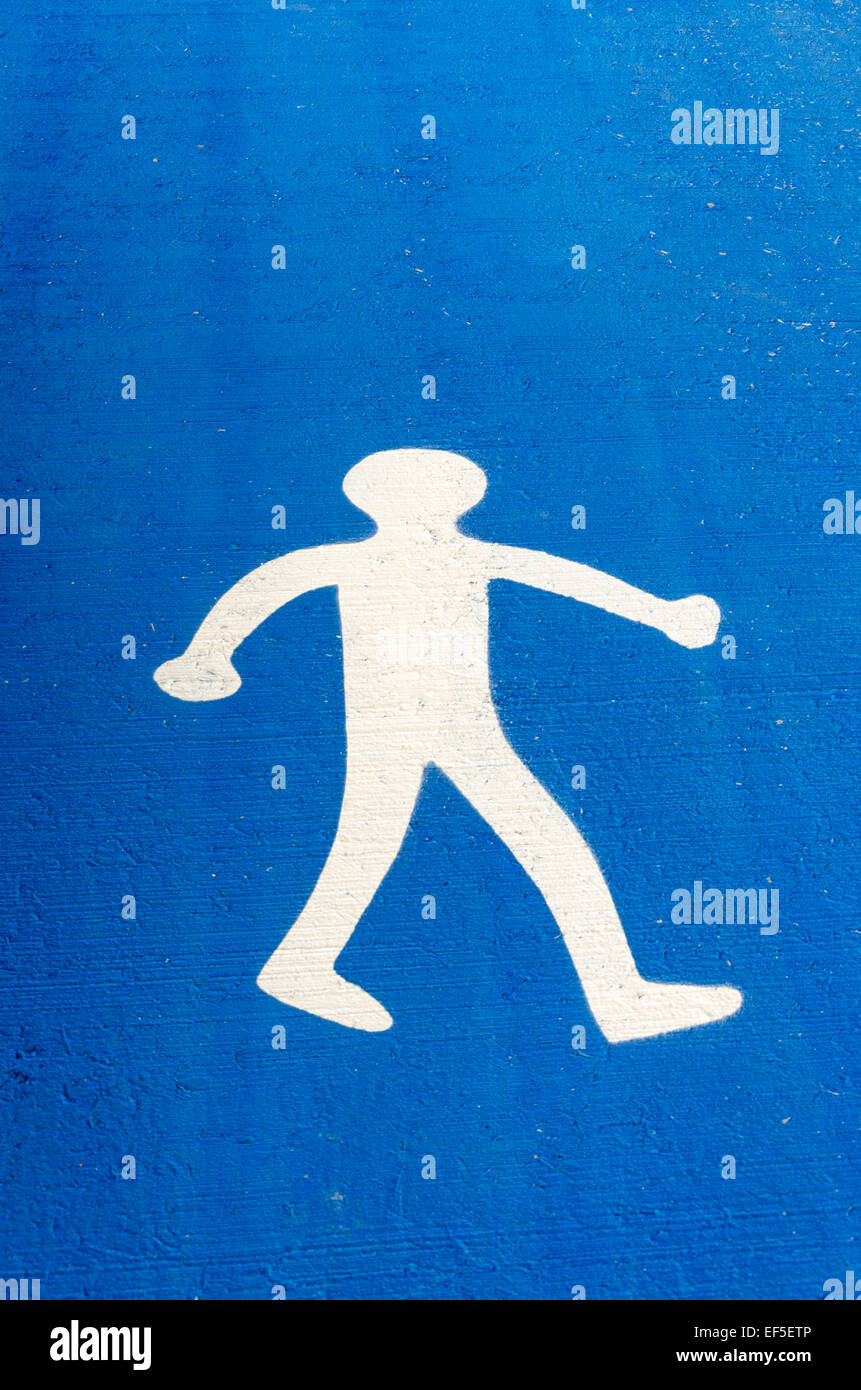 Blue pedestrian path with graphic of person walking Stock Photo - Alamy
