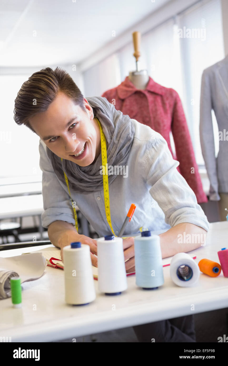 Smiling student drawing on notebook Stock Photo - Alamy