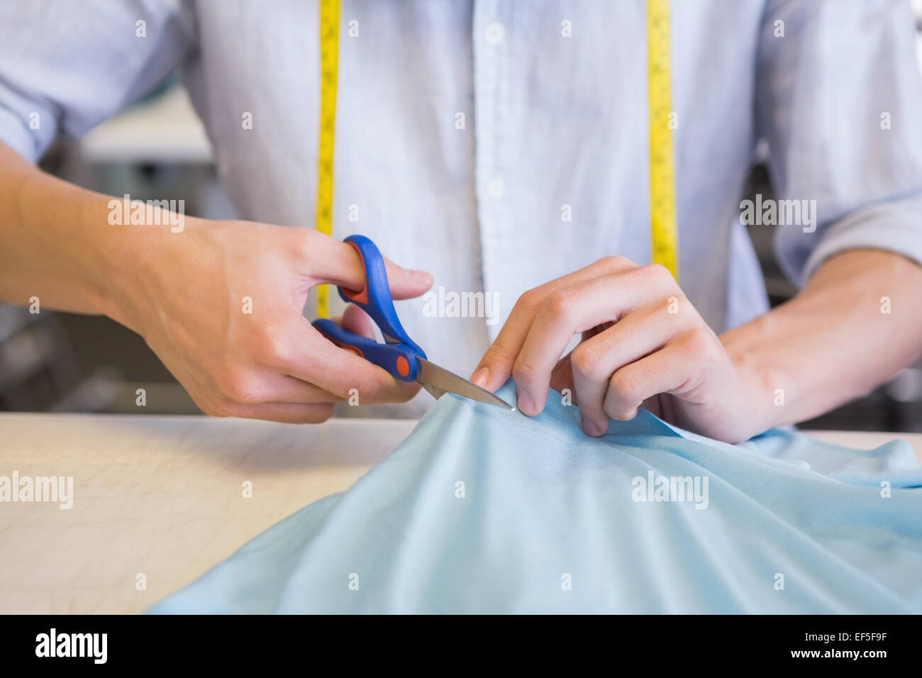 Student cutting fabric with pair of scissors Stock Photo - Alamy