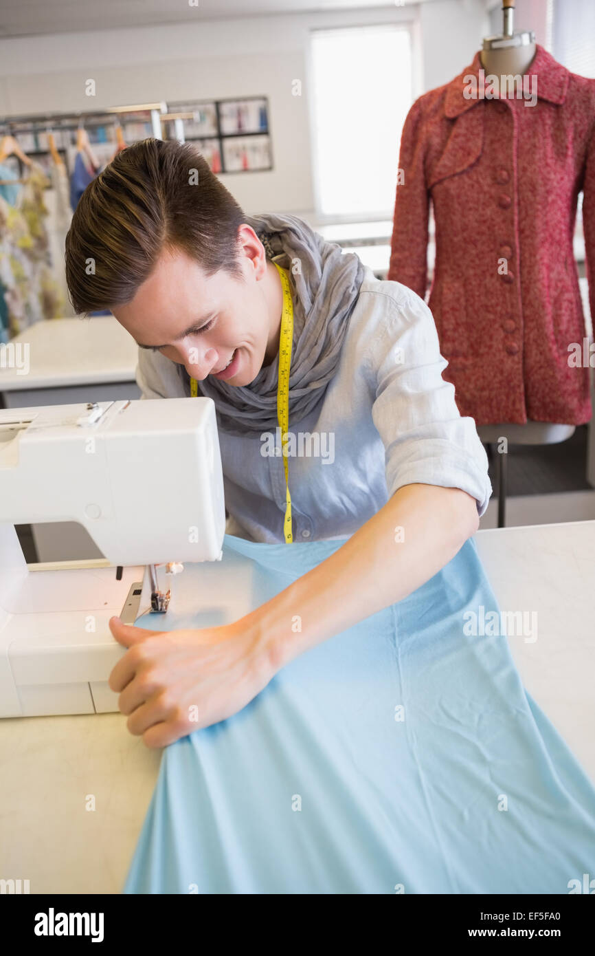 Smiling student using sewing machine Stock Photo - Alamy
