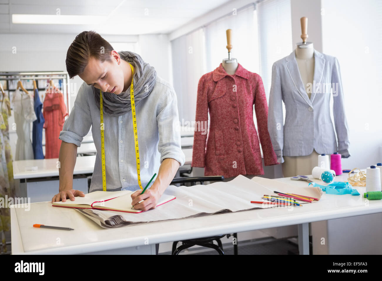 Fashion student taking notes on notebook Stock Photo - Alamy
