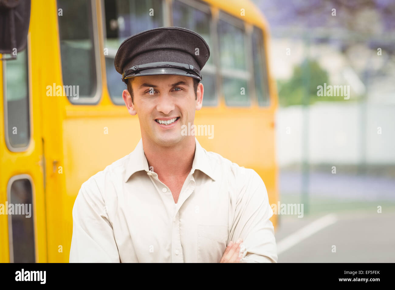 Smiling bus driver looking at camera Stock Photo - Alamy