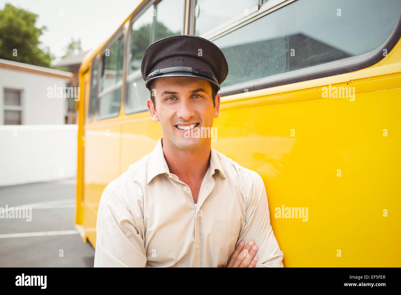 Smiling bus driver looking at camera Stock Photo - Alamy