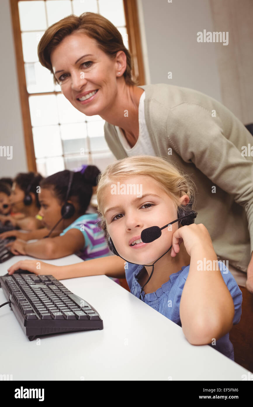 Cute pupils in computer class with teacher Stock Photo - Alamy