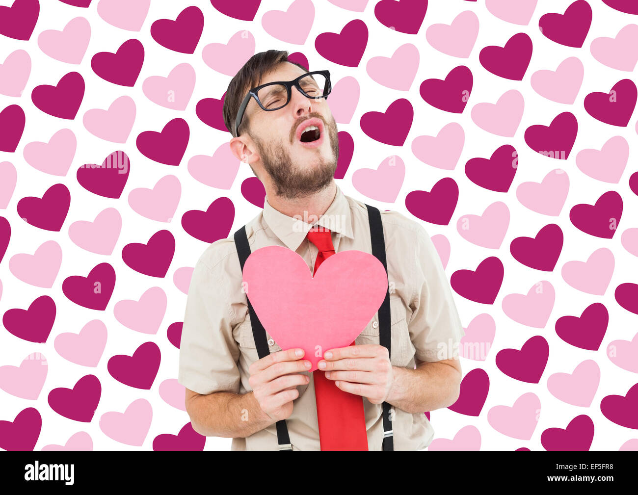 Composite image of geeky hipster crying and holding heart card Stock ...