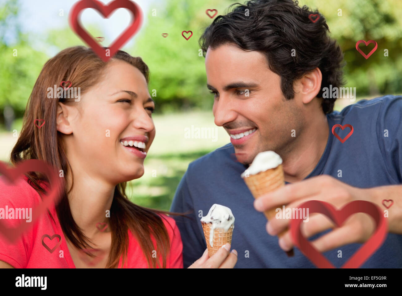 Composite image of two friends laughing while holding ice cream Stock ...