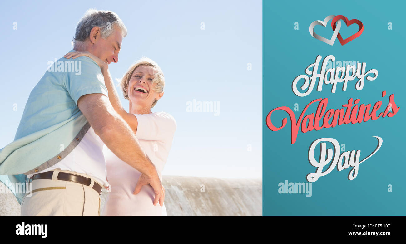 Composite image of senior woman hugging her partner Stock Photo - Alamy