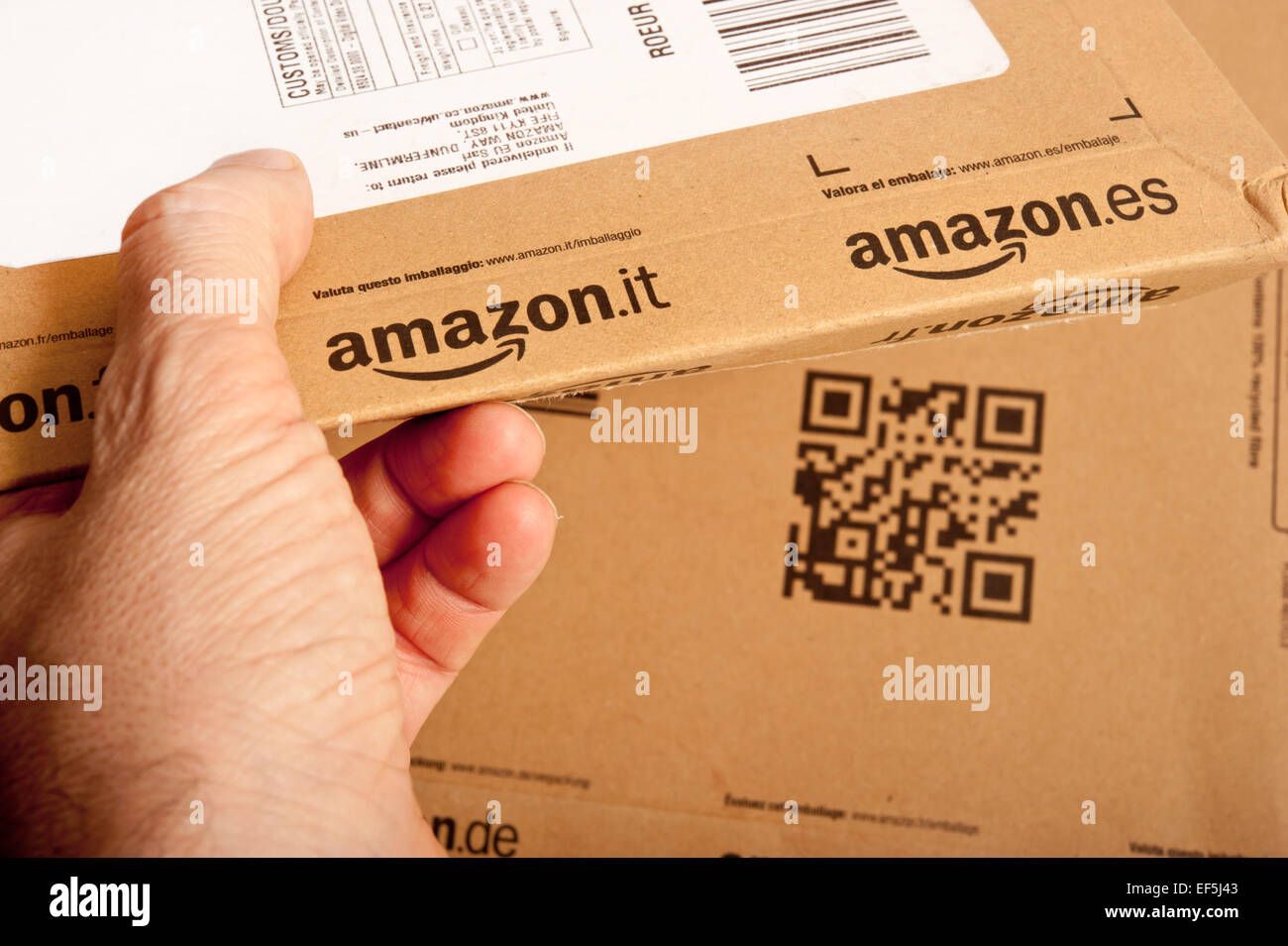 hand holding an Amazon cardboard parcel Stock Photo - Alamy