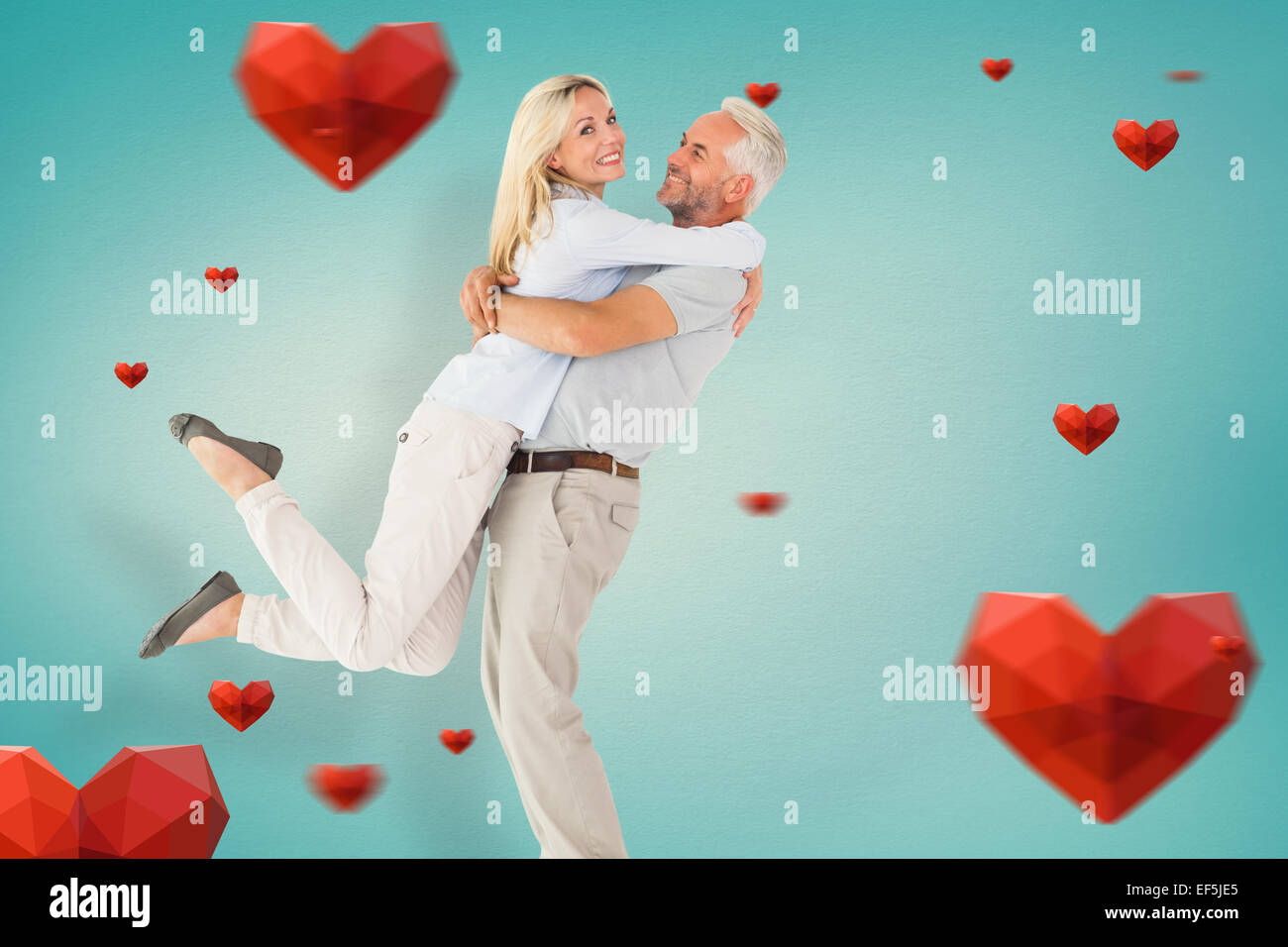 Composite image of man picking up his partner while hugging here Stock ...