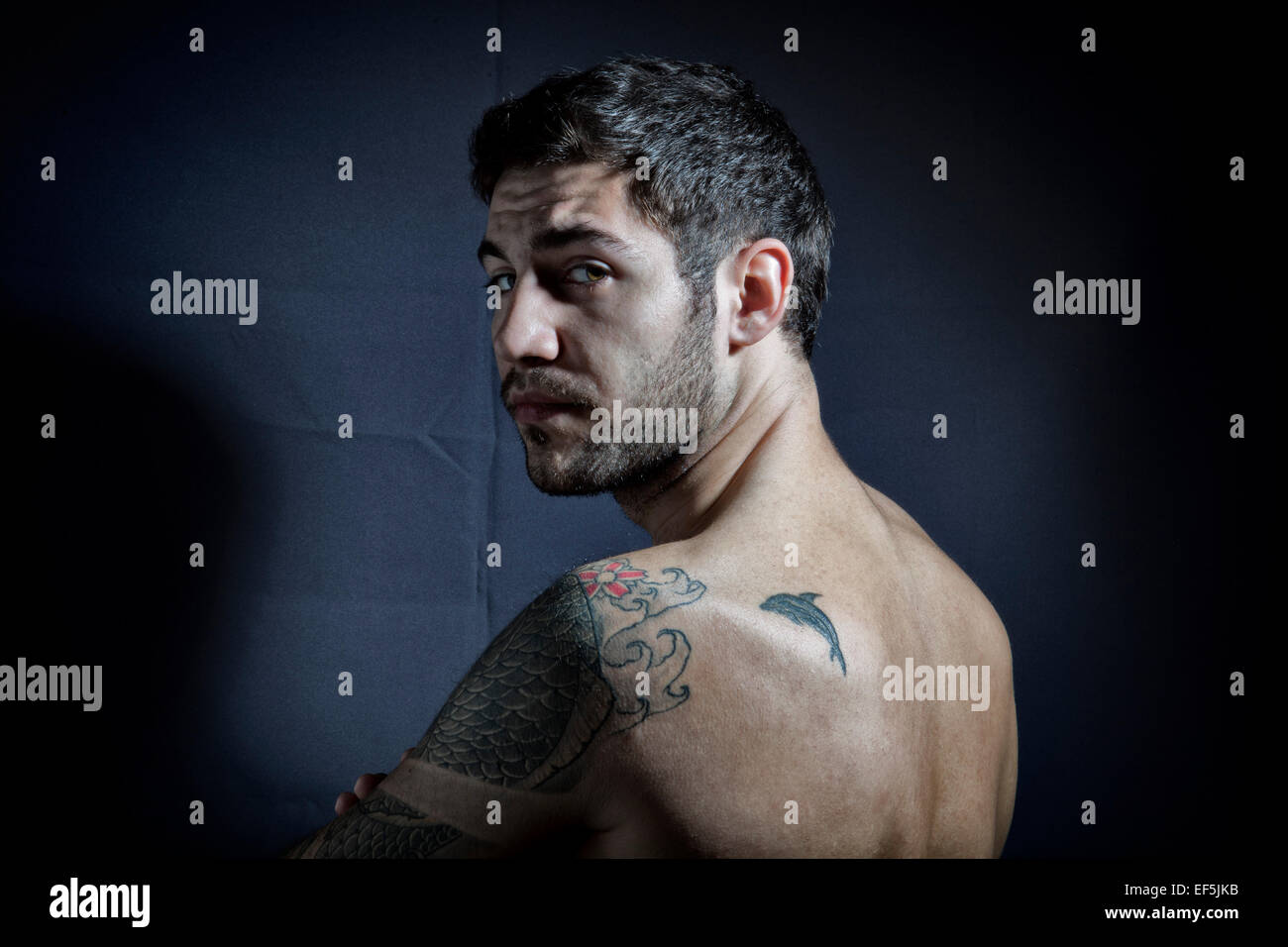 Portrait of young man with tattoos Stock Photo - Alamy