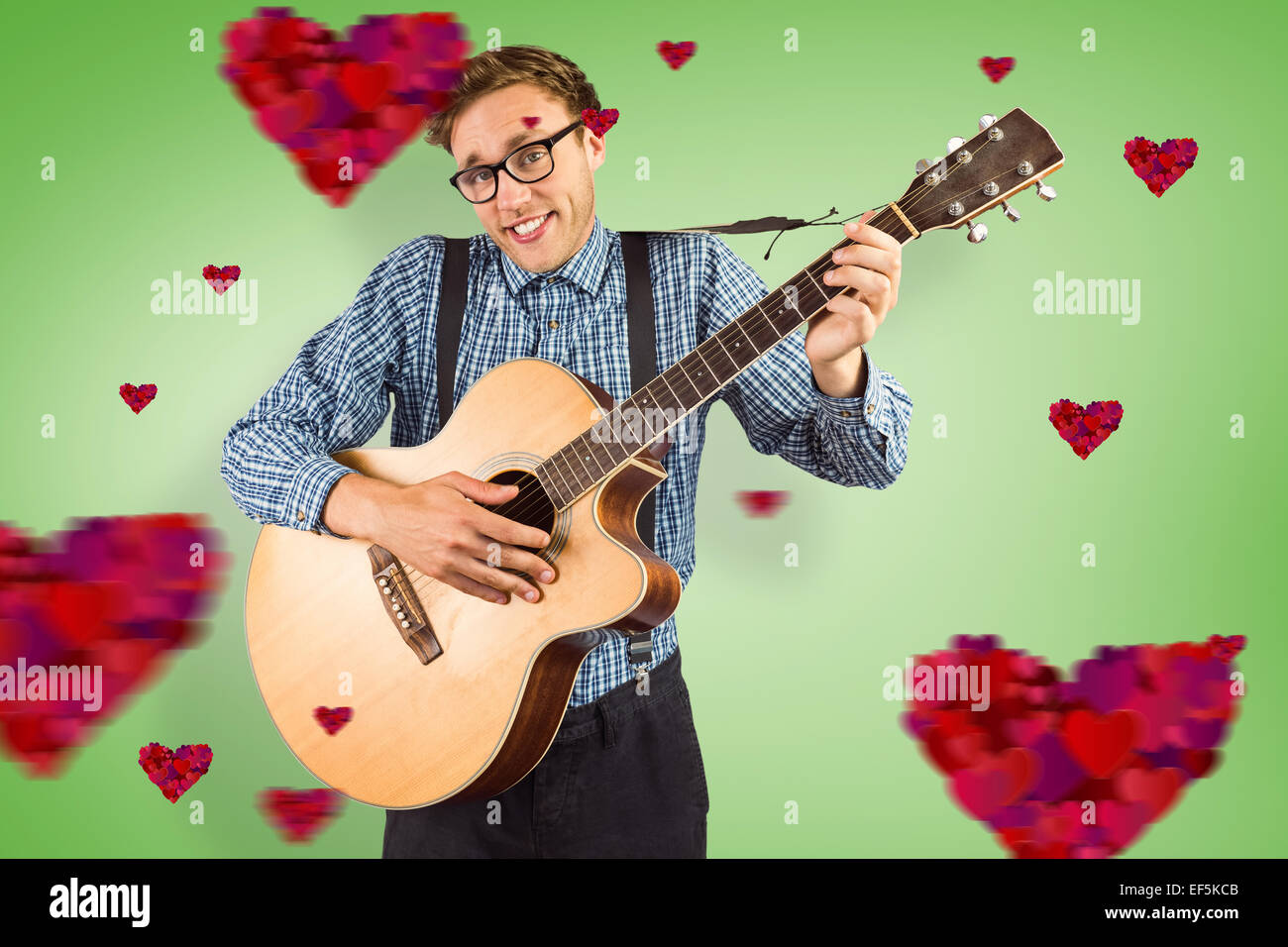 Composite image of geeky hipster playing the guitar Stock Photo - Alamy