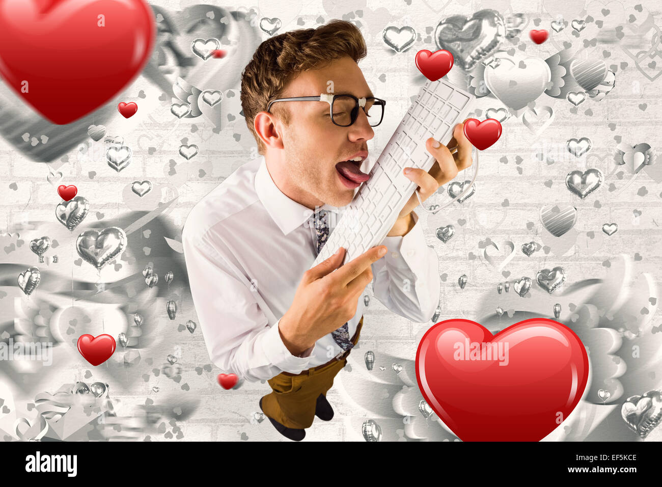 Composite image of geeky businessman licking his keyboard Stock Photo ...