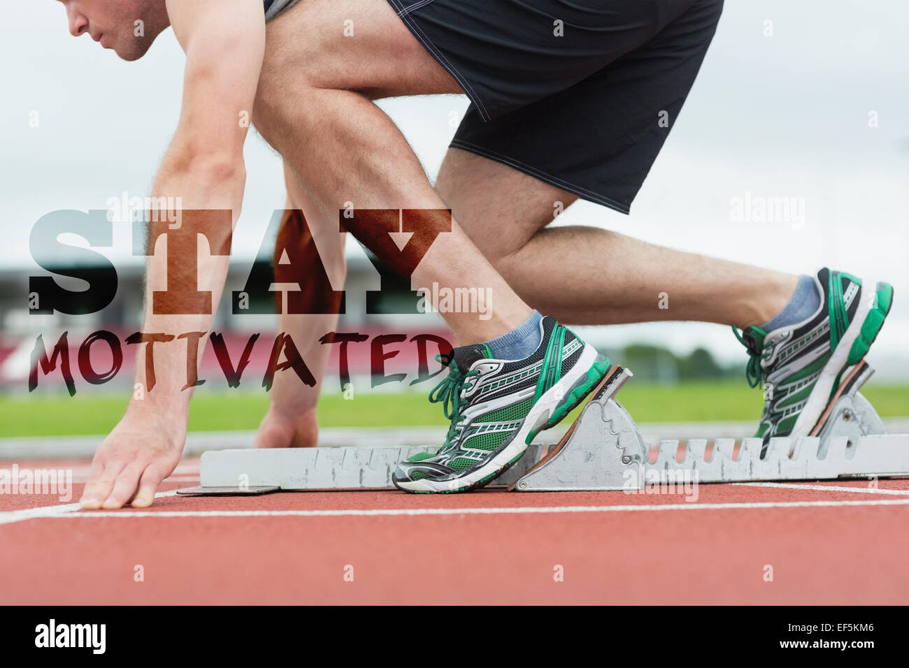 Composite image of side view of a man ready to race on running trac ...