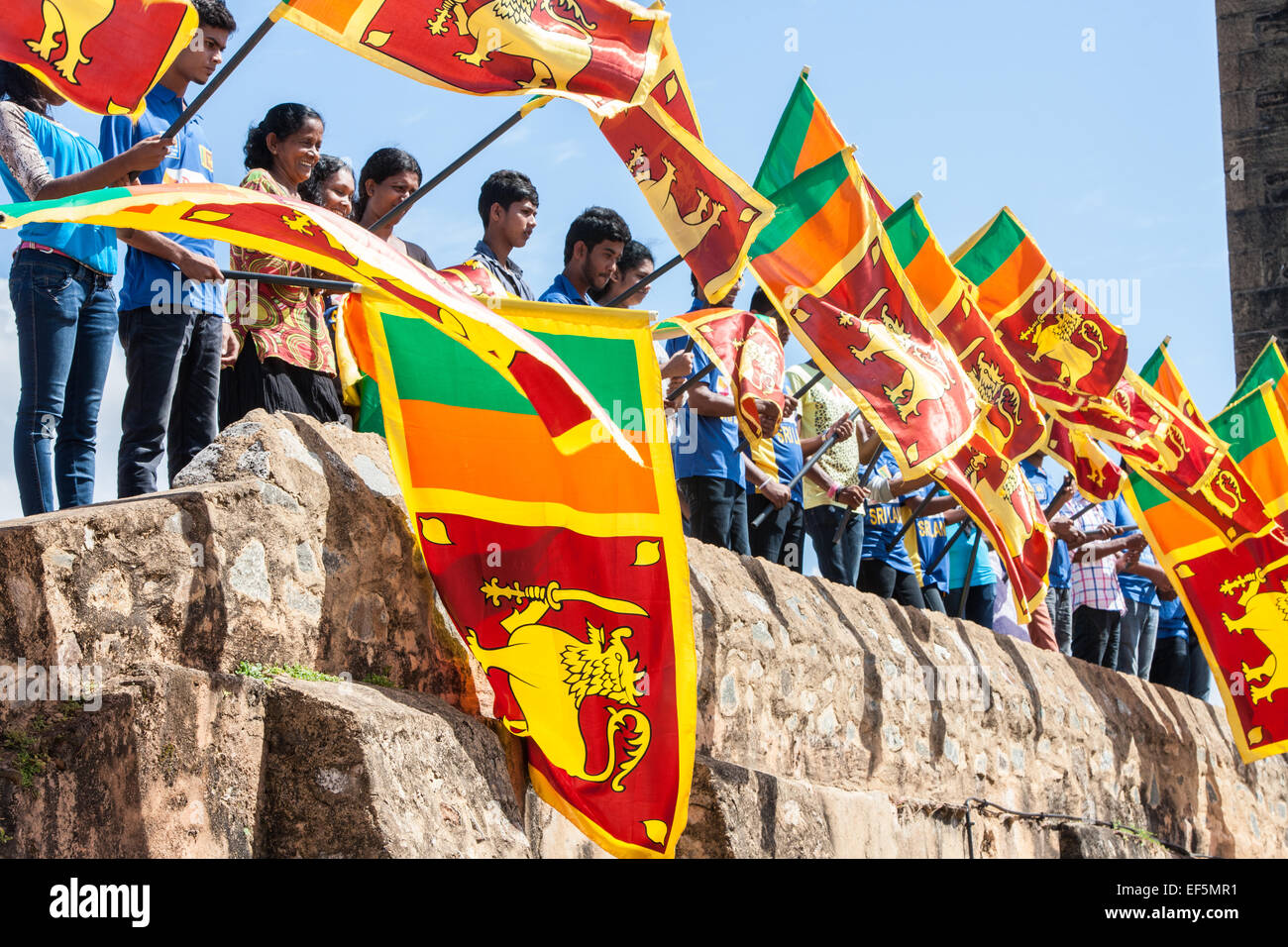 Sri Lanka flag flags, being waved by locals at Dutch Fort clock tower ...