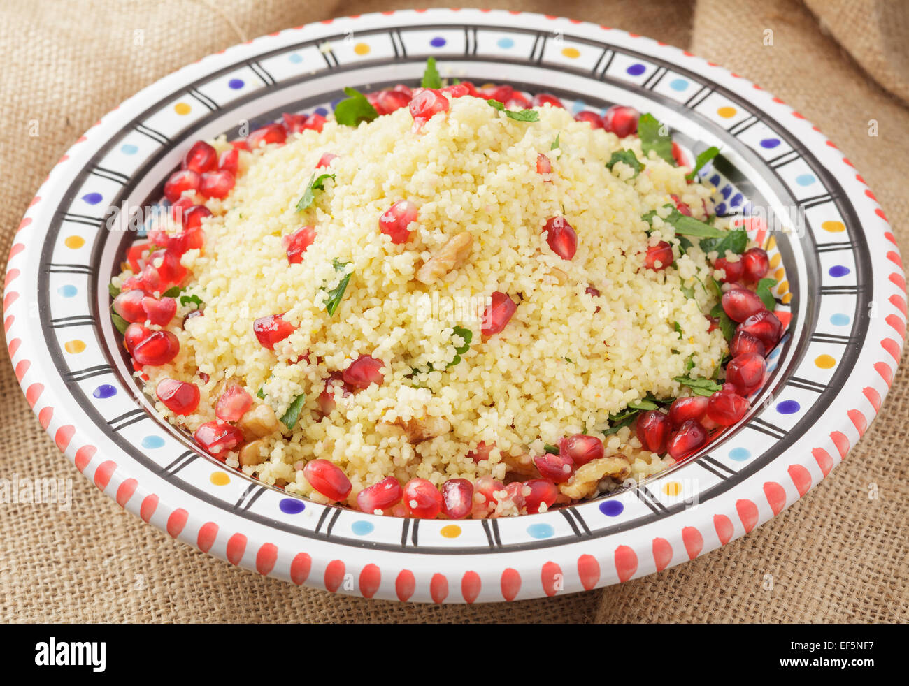 couscous with pomegranate seeds, walnuts and parsley Stock Photo - Alamy