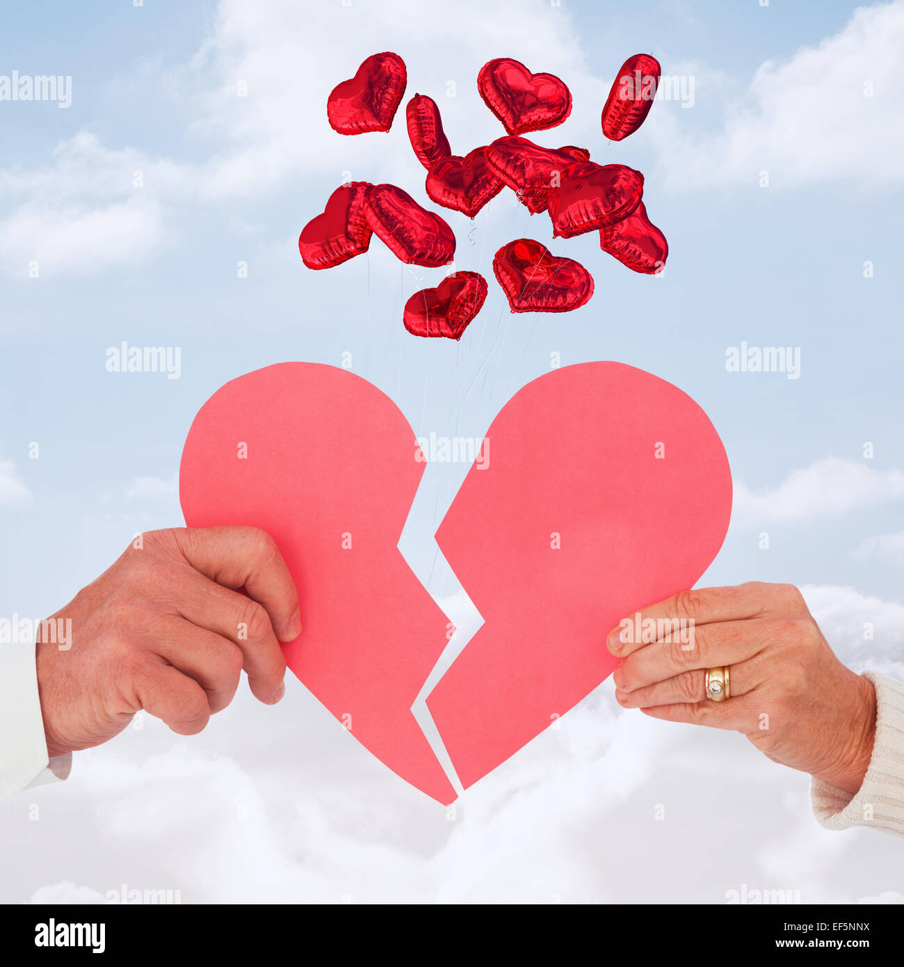 Composite image of couple holding a broken paper heart Stock Photo - Alamy