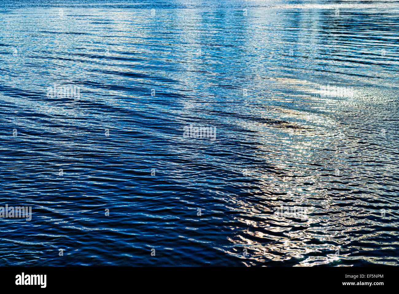 Sunlight reflecting off the ripples of a lake Stock Photo - Alamy