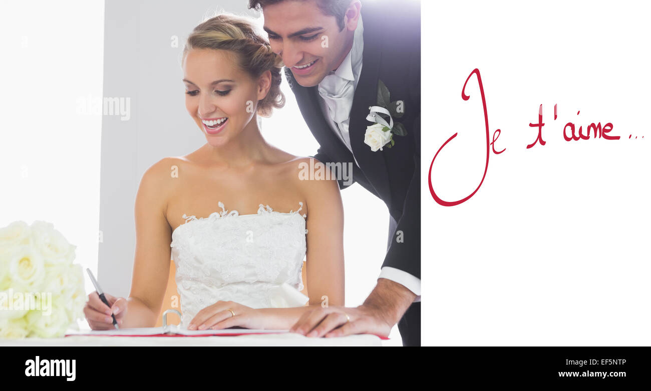 Composite image of happy young couple signing wedding register Stock ...