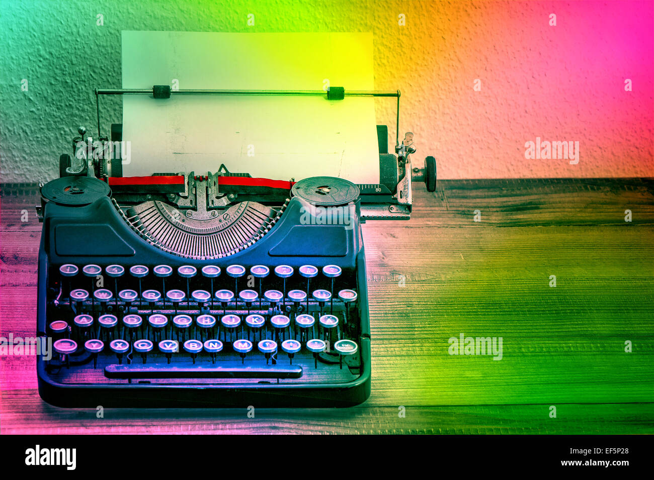 Vintage typewriter on wooden table with color spot lights. Retro style ...