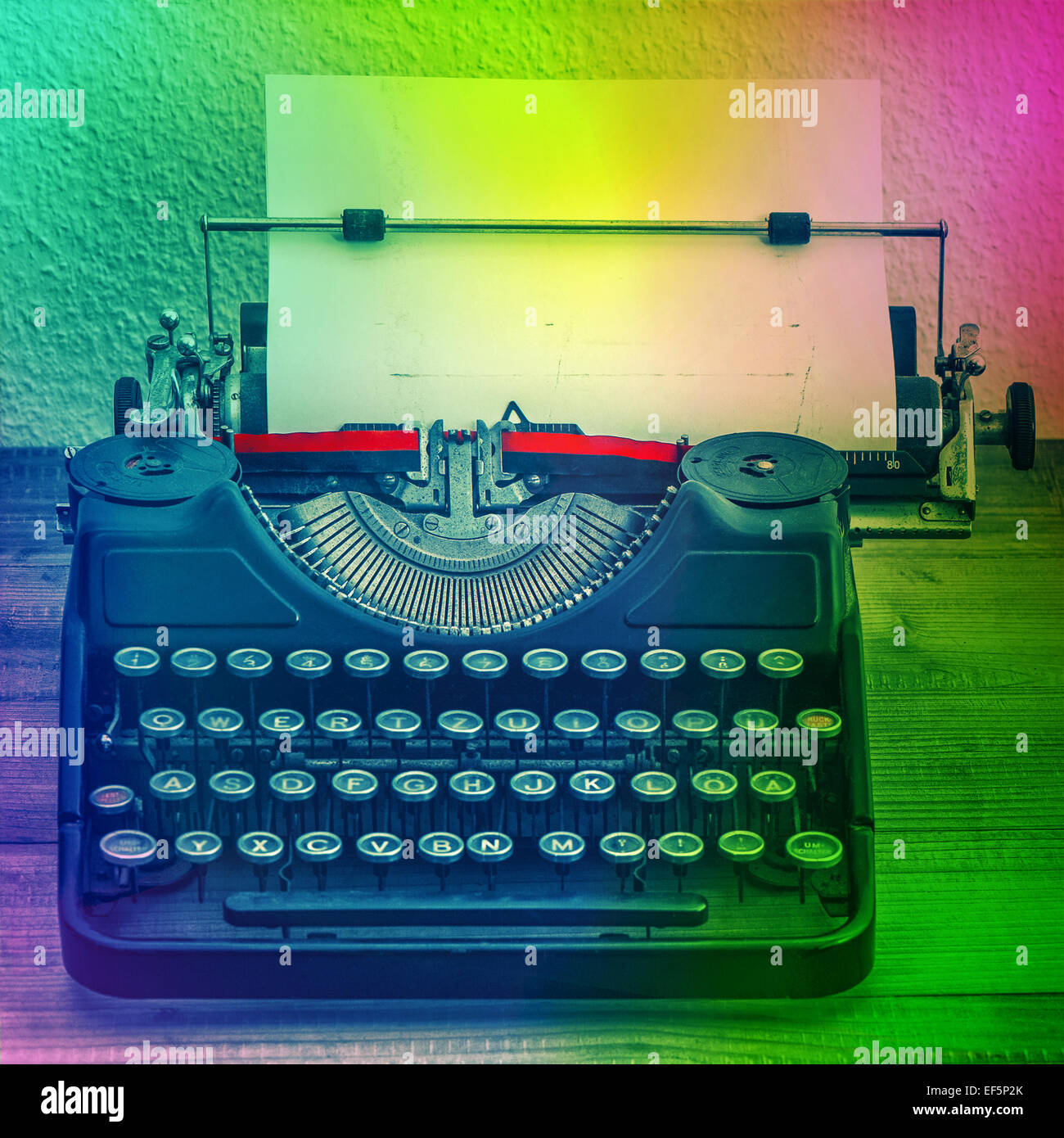 Vintage typewriter on wooden table with color spot lights. Retro style ...