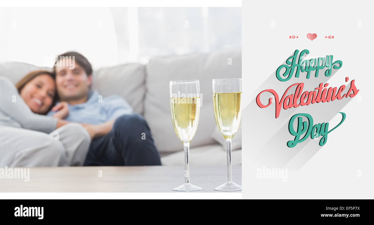 Composite image of couple resting on a couch with flutes of champagne ...