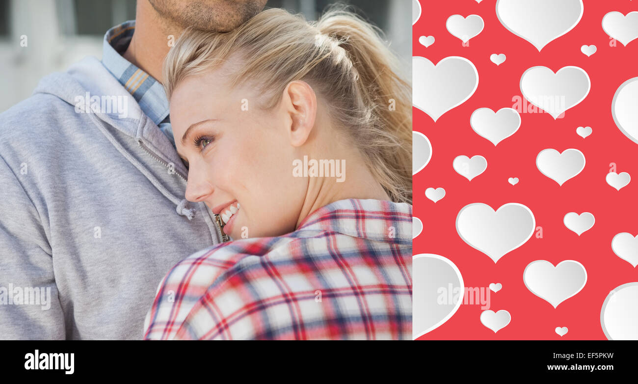 Composite image of hip young couple hugging each other Stock Photo - Alamy