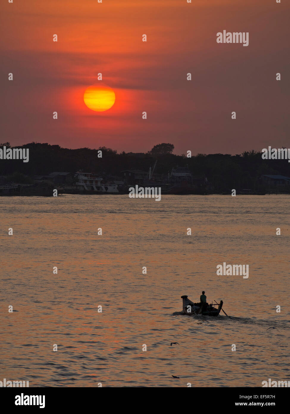 Fishing boat at sunset in the harbour in Yangon, Myanmar Stock Photo ...
