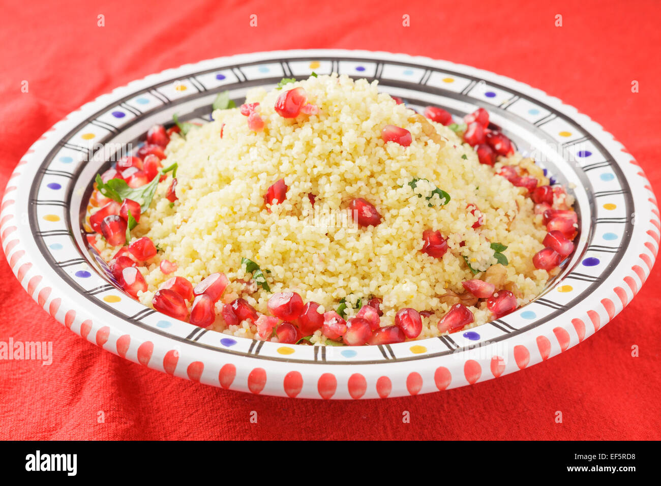couscous with pomegranate seeds, walnuts and parsley Stock Photo - Alamy