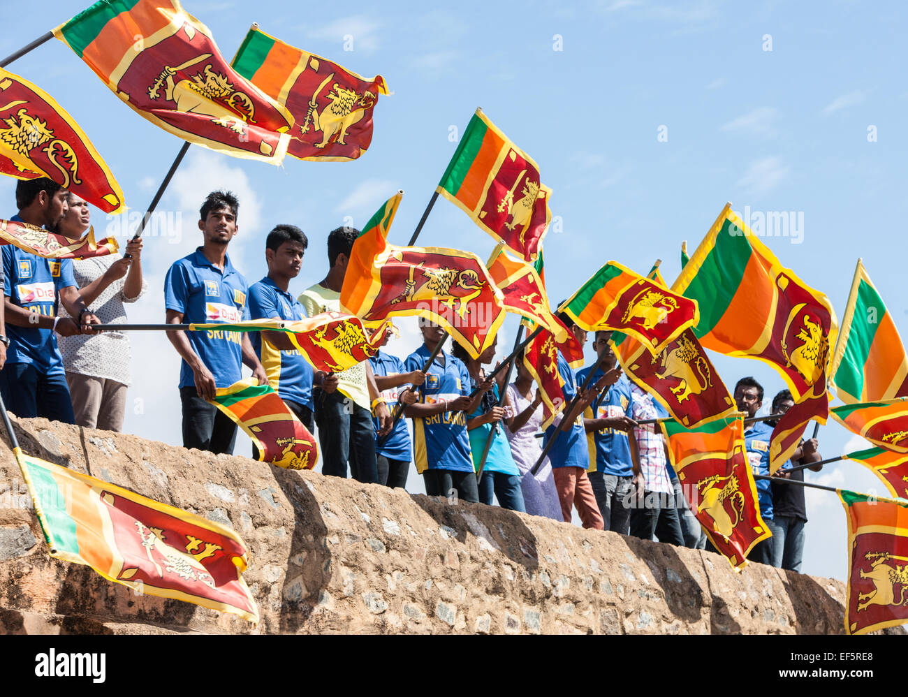 Sri Lanka flag flags, being waved by locals at Dutch Fort clock tower ...