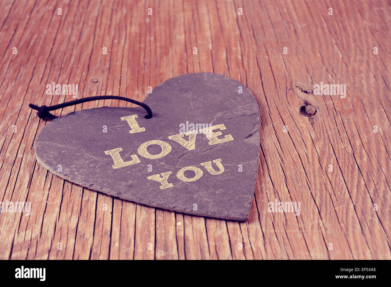 the sentence text I love you written in a heart-shaped natural slate ...