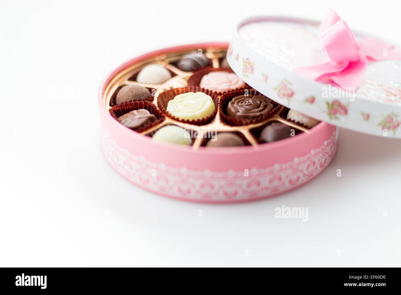 Pink box of chocolates with ribbon on white background Stock Photo - Alamy