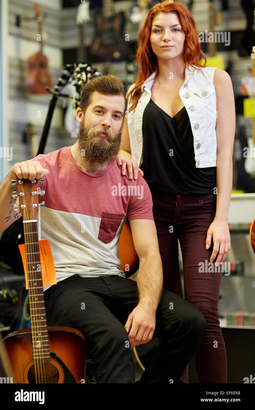 couple of musicians with guitar at music store Stock Photo - Alamy
