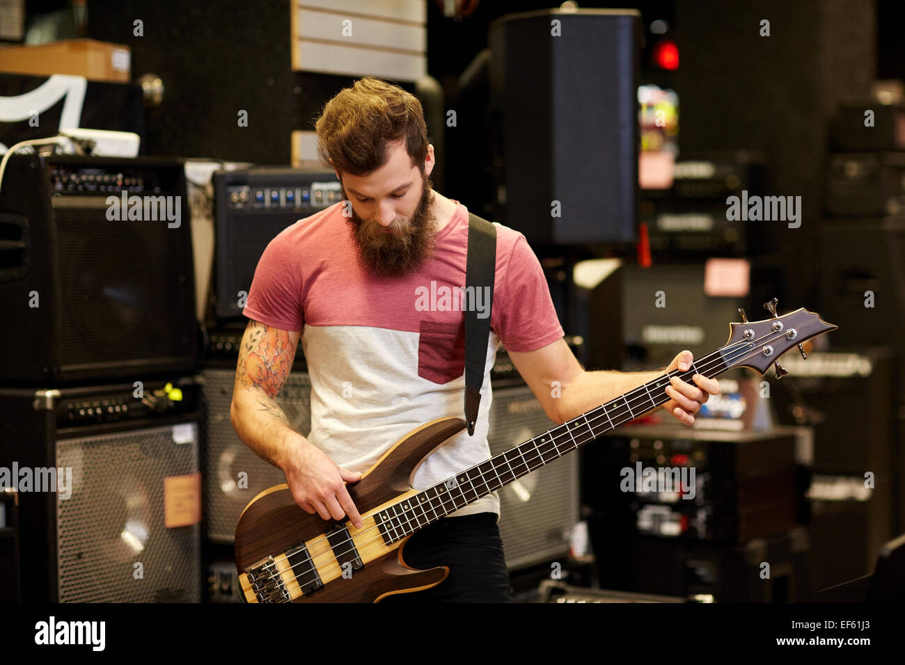 musician or customer with guitar at music store Stock Photo - Alamy
