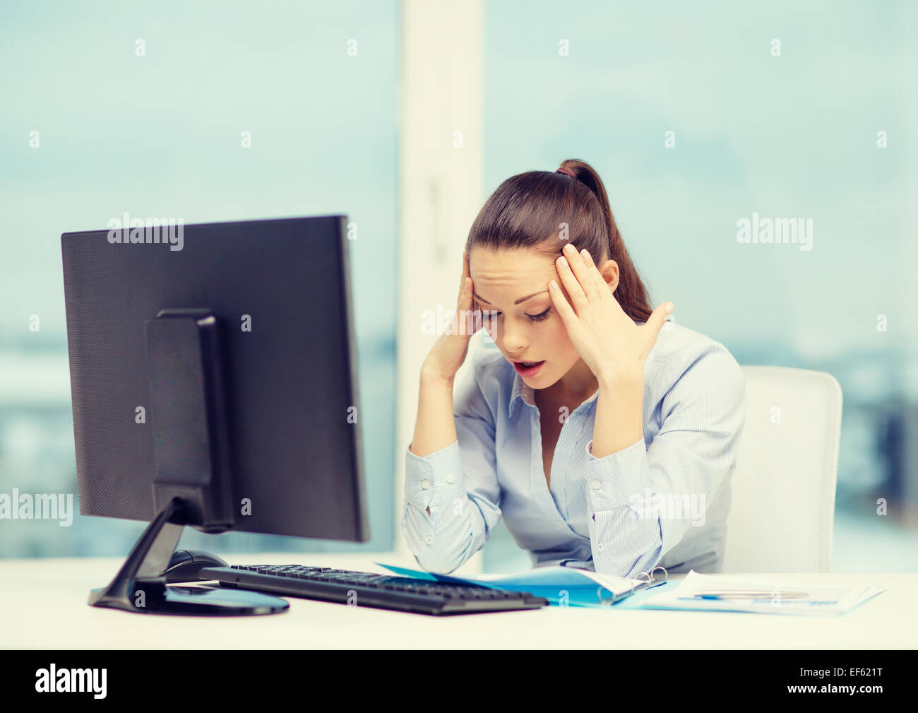 stressed woman with computer and documents Stock Photo - Alamy