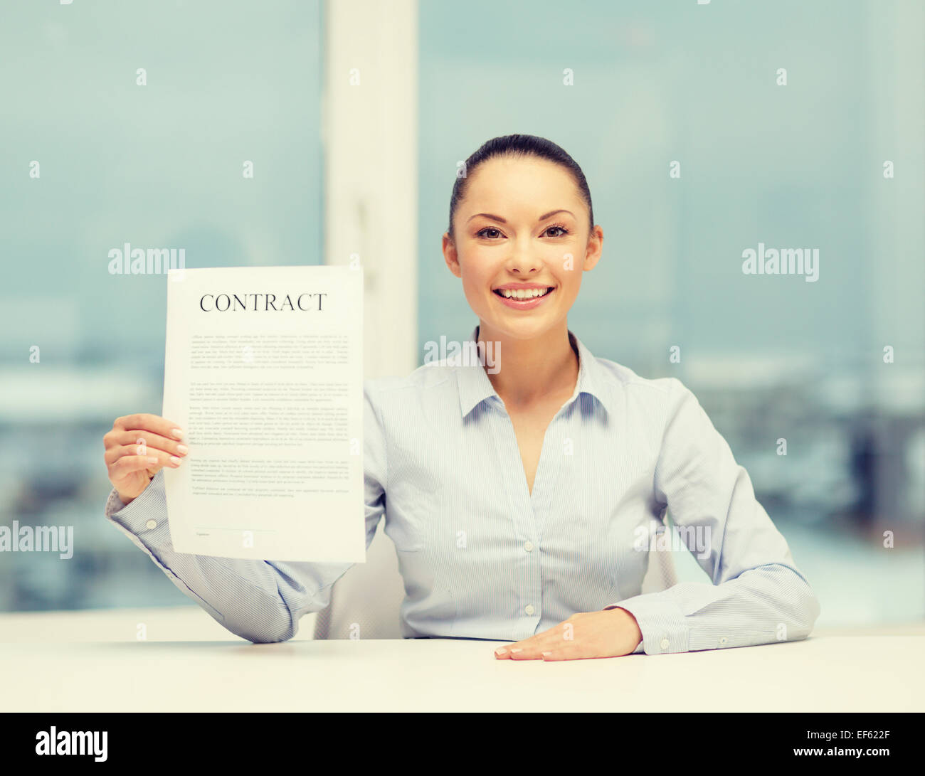 happy businesswoman holding contract in office Stock Photo - Alamy