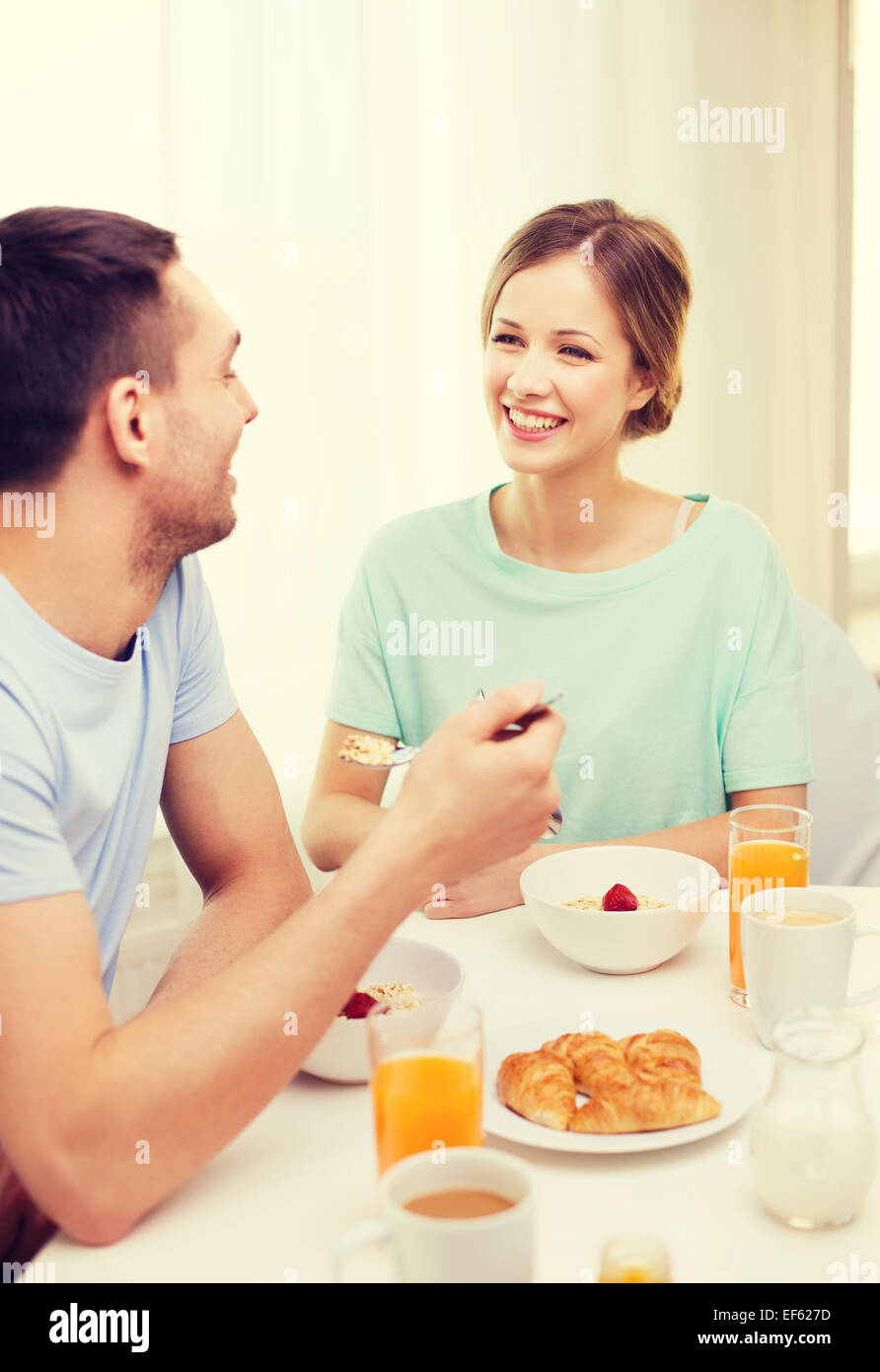 smiling couple having breakfast at home Stock Photo - Alamy