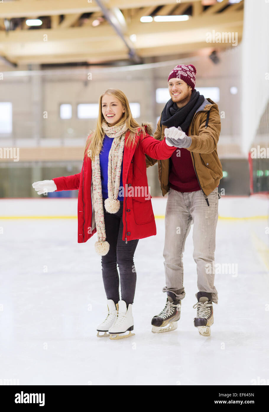 happy couple on skating rink Stock Photo - Alamy