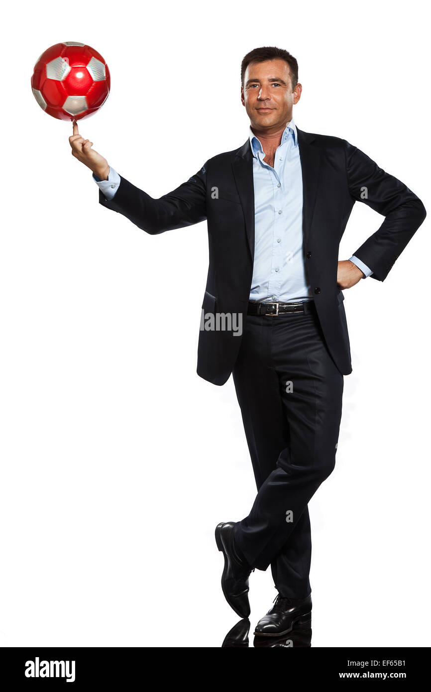 one caucasian business man playing juggling soccer ball in studio ...