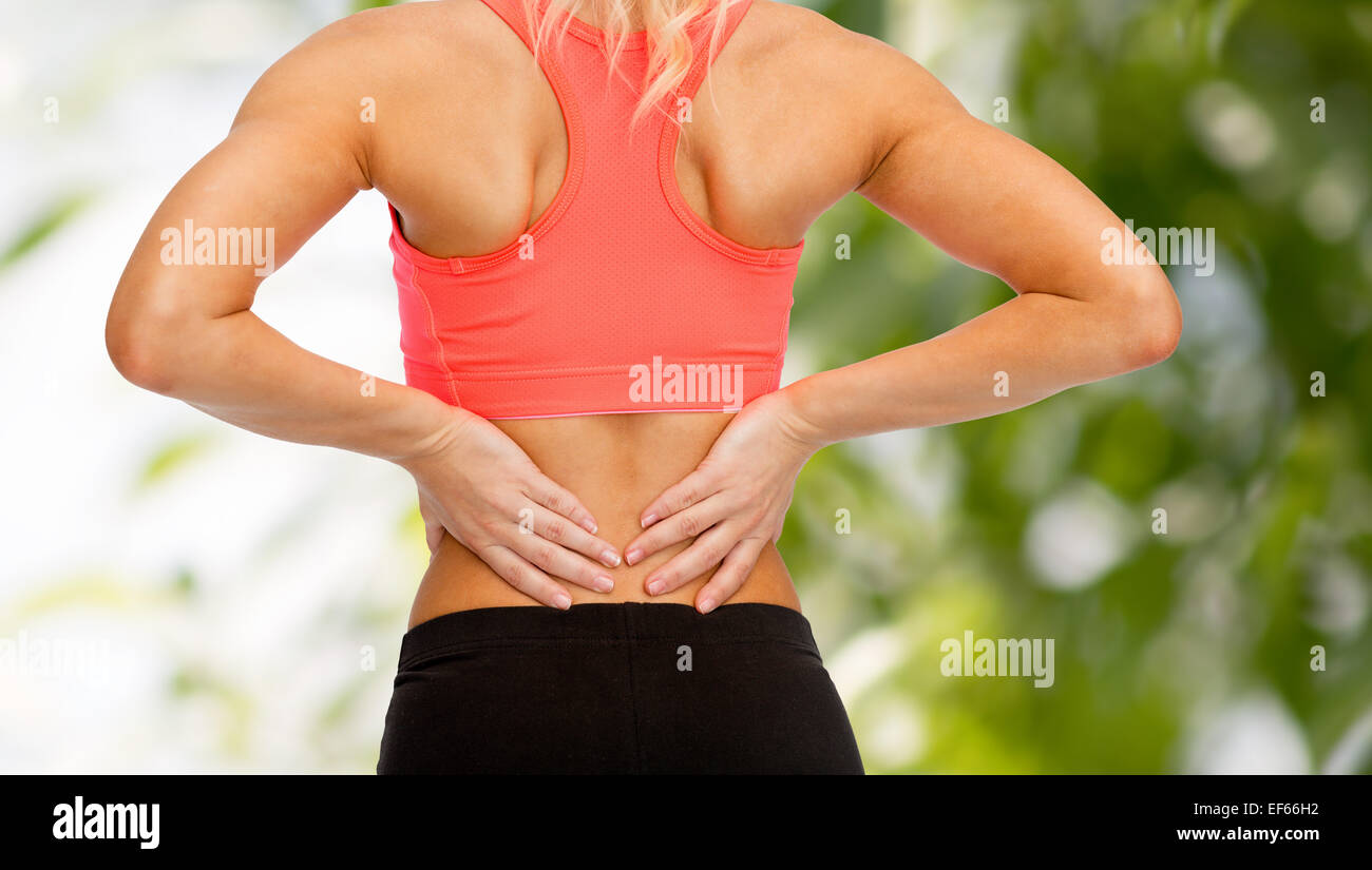close up of sporty woman touching her back Stock Photo - Alamy