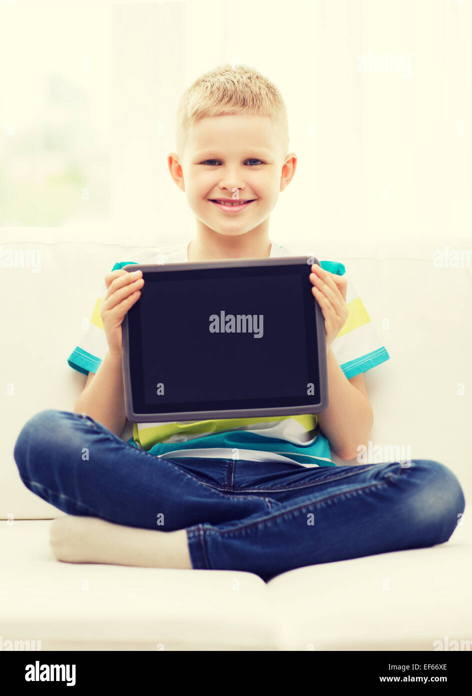 smiling boy with tablet pc computer at home Stock Photo - Alamy