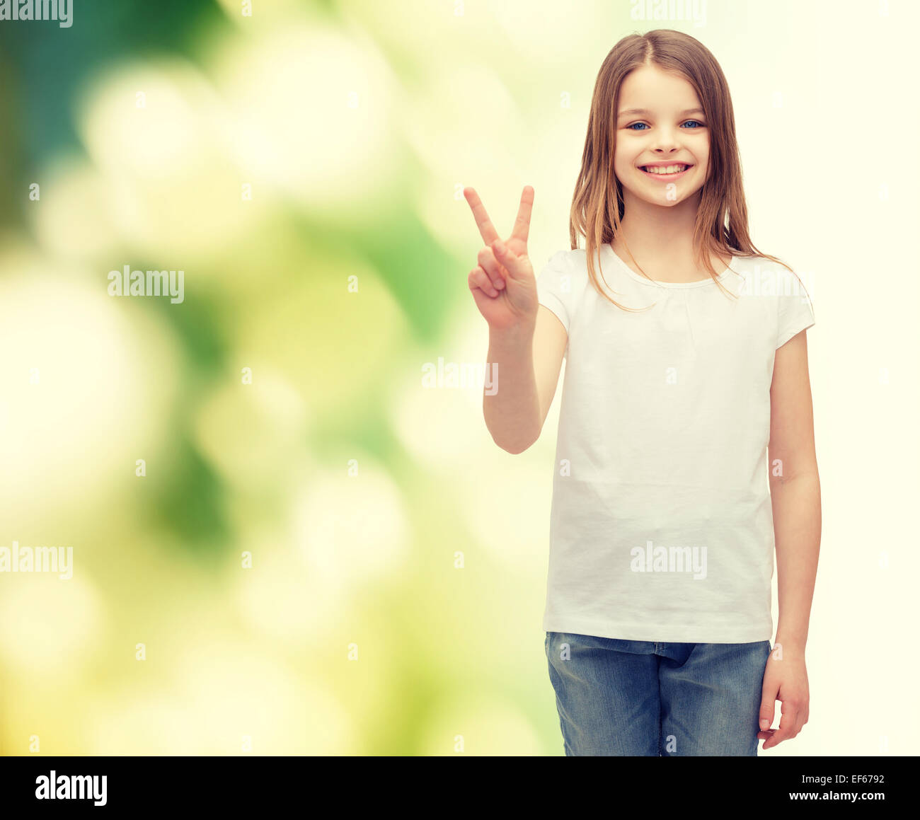 little girl in white t-shirt showing peace gesture Stock Photo - Alamy