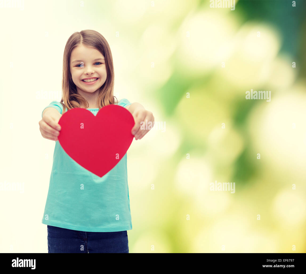smiling little girl giving red heart Stock Photo - Alamy