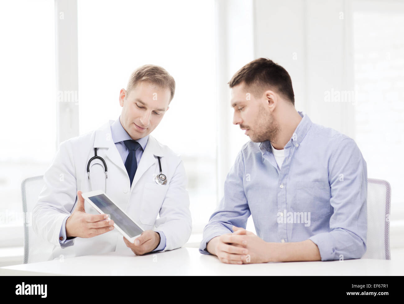 doctor with tablet pc and patient in hospital Stock Photo - Alamy