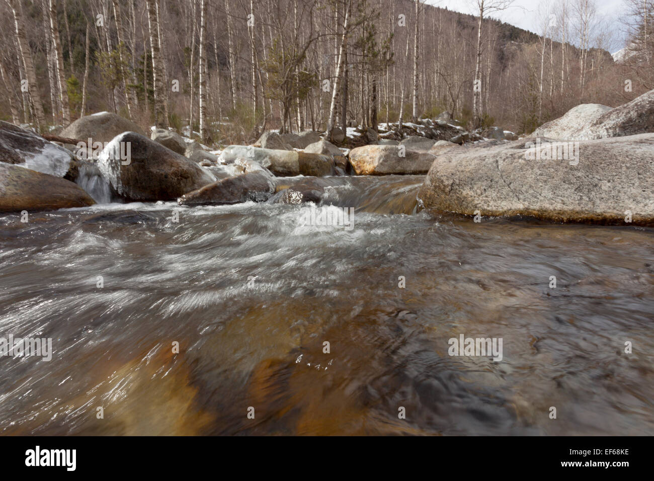 Snow-covered landscape and river with moving water Stock Photo - Alamy